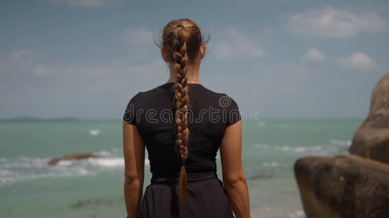 Athletically Built Female Standing on the Big Stone by the Ocean and ...