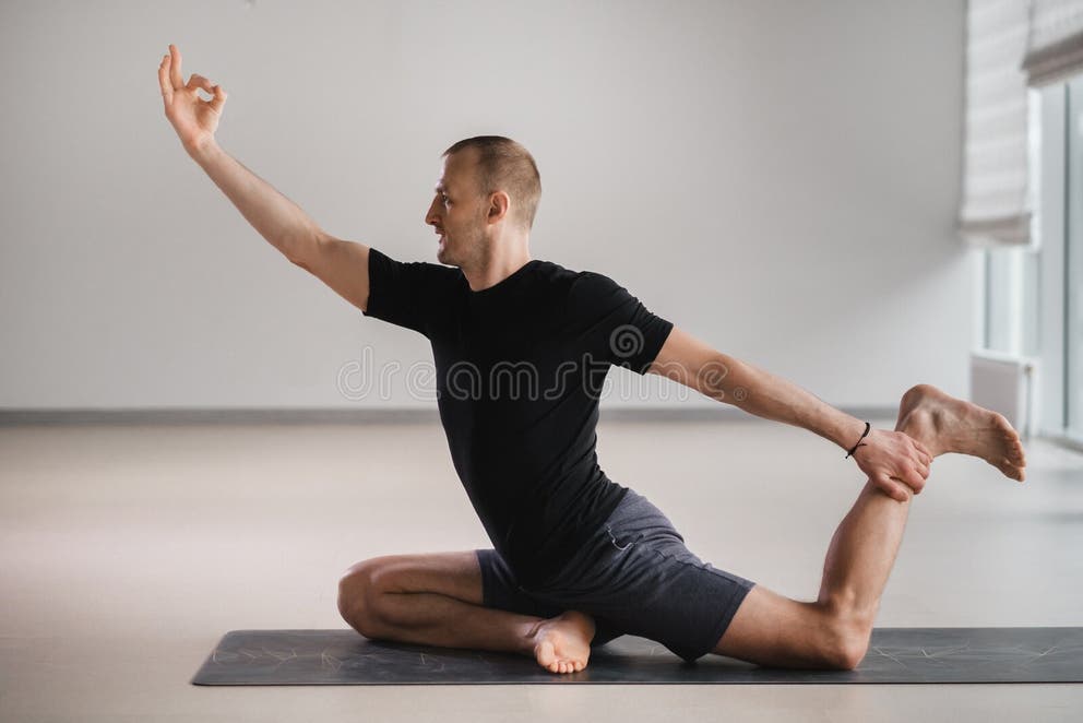 An Athletically Built Man Does Yoga in the Gym on a Mat Stock Image ...