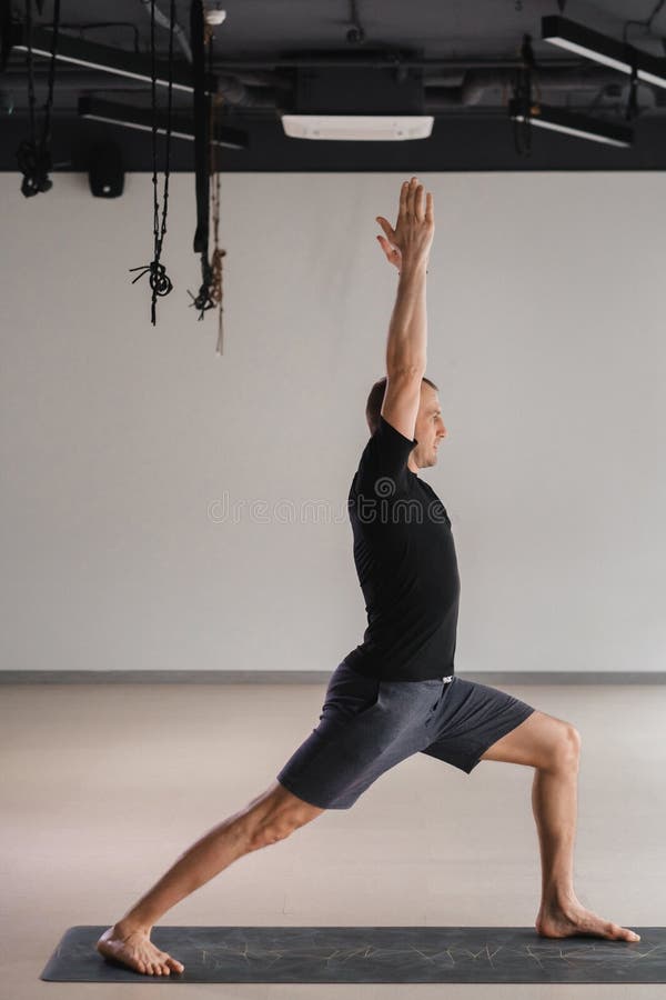 An Athletically Built Man Does Yoga in the Gym on a Mat Stock Image ...