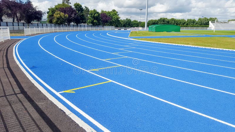 Athletics Running Blue Track in a Sports Stadium Stock Photo - Image of ...