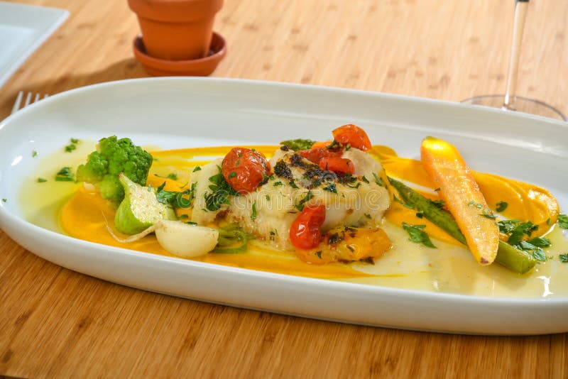 Atlantic Cod Dish Served with Asparagus, Red Tomatoes and Vegetables ...