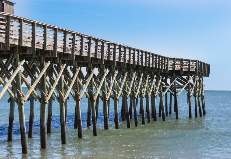 Wooden Fishing Pier Extending From Shore Into The Ocean Stock Photo ...