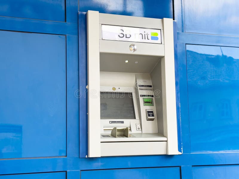 ATM Machine Mounted on a Blue Wall, Showcasing Modern Banking ...