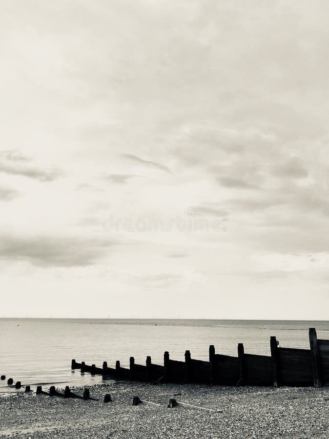 Atmospheric Beach Scene on a Cloudy Day, with a Person Walking Along ...