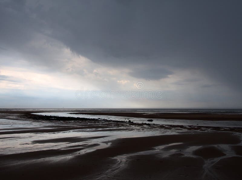 Atmospheric Beach Scene on a Cloudy Day, with a Person Walking Along ...