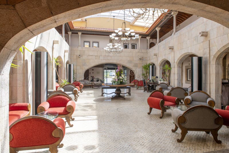 Atrium with Glass Ceilings and White Marble Floors and Stone Walls ...