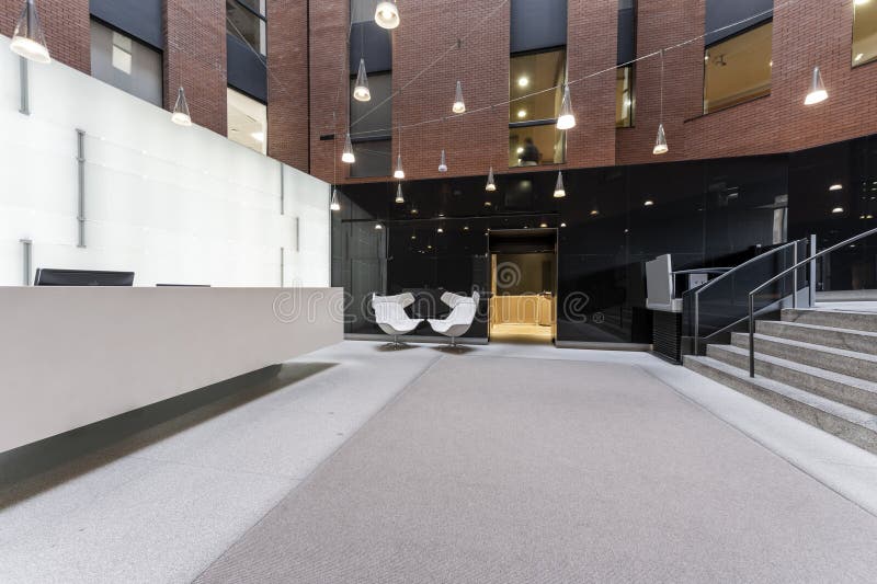 Atrium of an Office Building with a Large Reception Desk, Granite ...