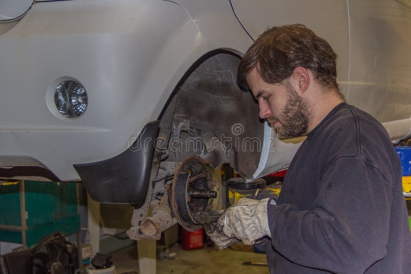 Auto mechanic in garage stock image. Image of grey, garage - 39632561