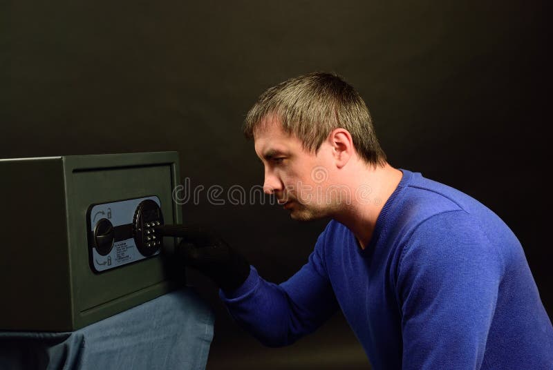 The Thief Breaks the Safe with a Combination Lock Stock Image - Image ...