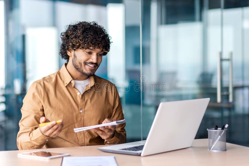 Attentive Arab Man Holding Notepad and Pen while Sitting by Table with ...