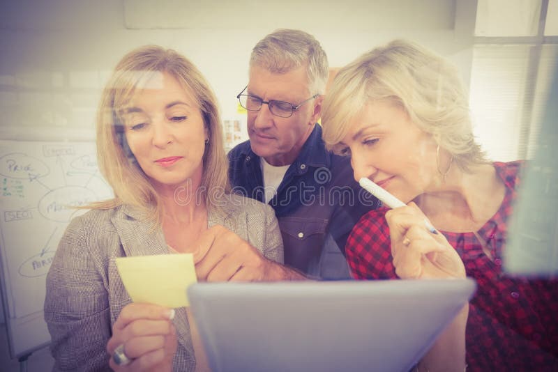 Attentive Business Team Looking at a Post it Stock Image - Image of ...