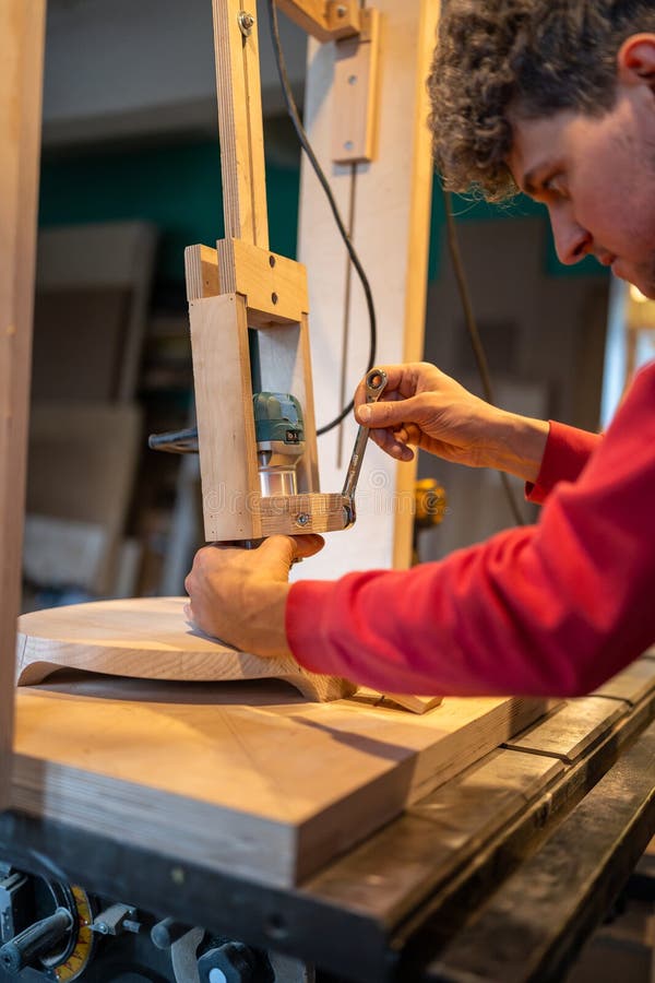 Attentive Carpenter Sets Up Milling Machine. Careful Man Tightens Tool ...