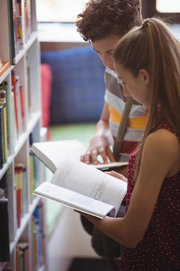 Attentive Classmates Reading Book in Library Stock Photo - Image of ...