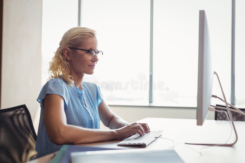 Attentive Executive Working at Personal Computer at Desk Stock Photo ...