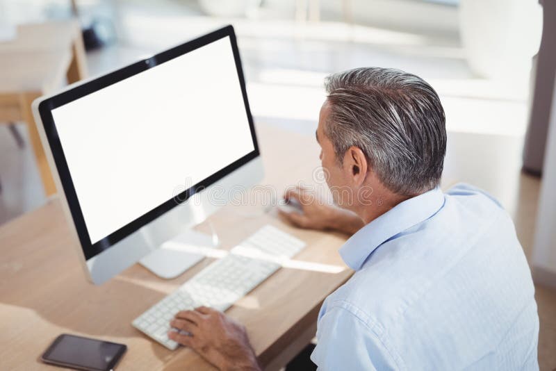 Attentive Executive Working on Personal Computer at Desk Stock Photo ...