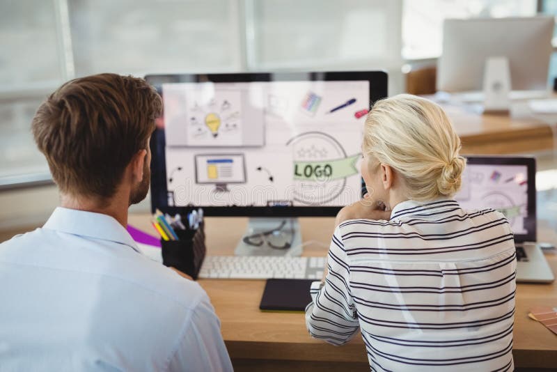 Attentive Graphic Designers Working Over Personal Computer at Desk ...