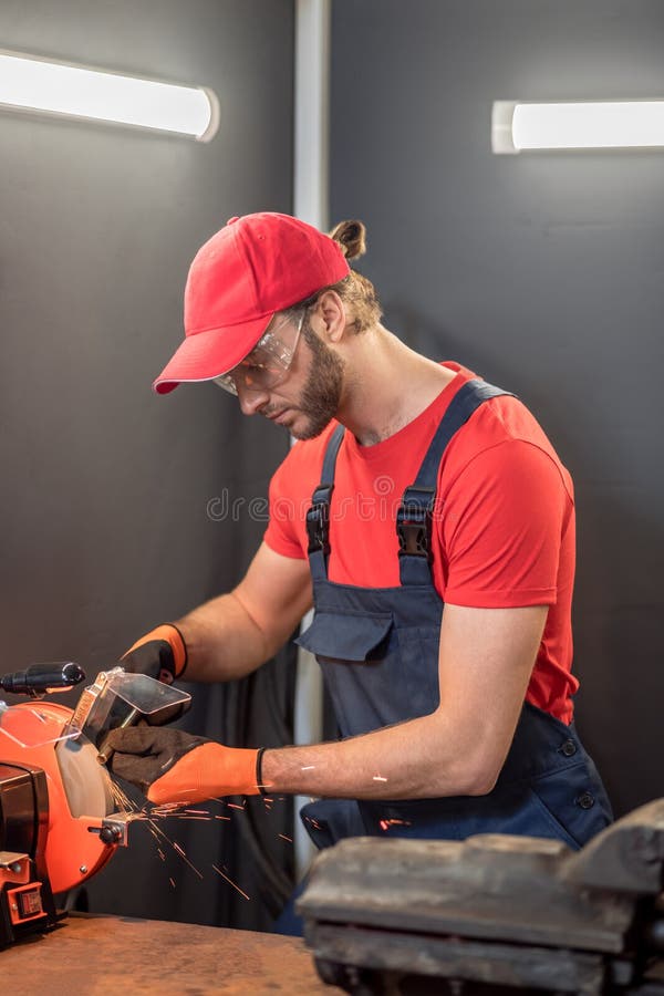 Attentive Man Machining Detail on Grinding Machine Stock Image - Image ...