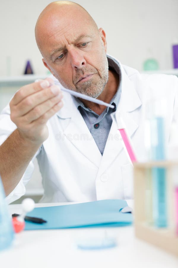 Attentive Mature Scientist Dripping Reagent into Test Tube Stock Photo ...