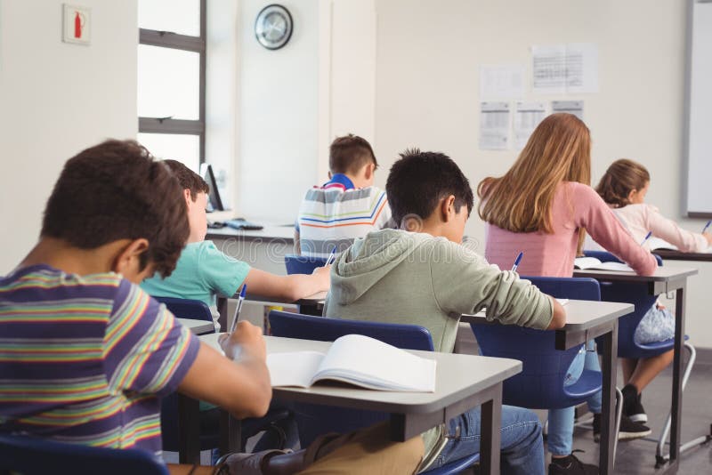Attentive School Kids Doing Homework in Classroom Stock Image - Image ...