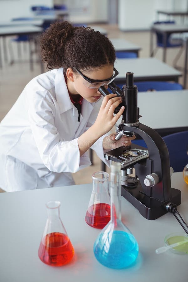 Attentive Schoolgirl Looking through Microscope in Laboratory Stock ...