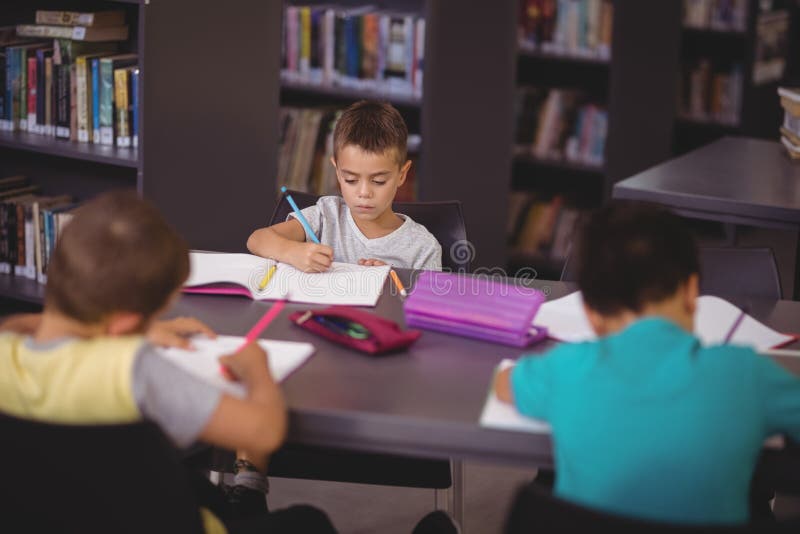 Attentive Schoolkids Doing Their Homework in Library Stock Photo ...