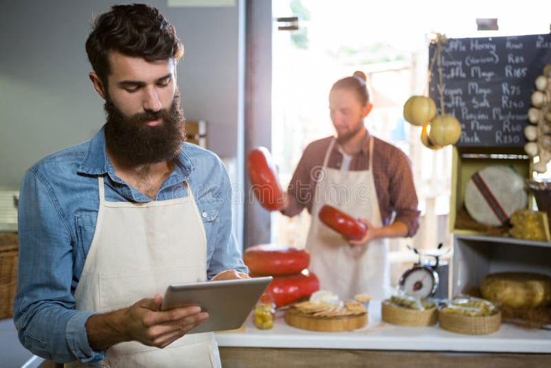 Attentive Staff Using Digital Tablet at Counter Stock Image - Image of ...