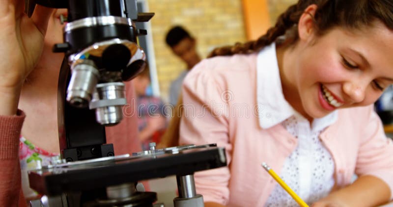Attentive Students Looking through Microscope in Laboratory Stock ...
