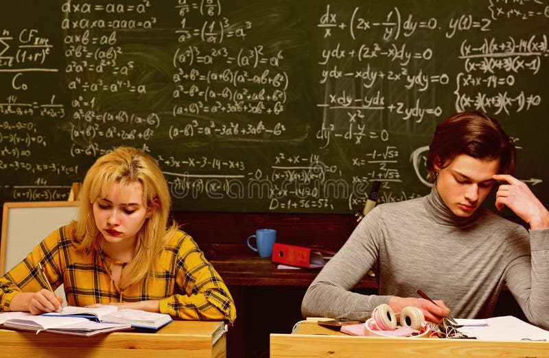 Attentive Students Writing Something in Their Note Pads while Sitting ...