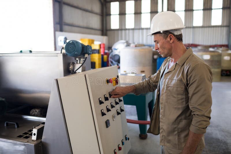 Attentive Technician Operating a Machine Stock Photo - Image of ...