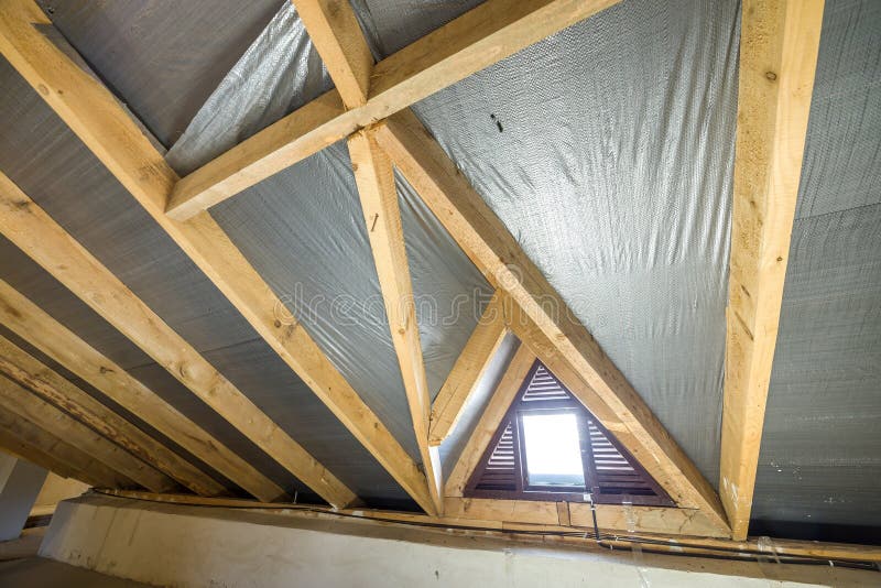 Attic of a Building with Wooden Beams of a Roof Structure and a Small ...