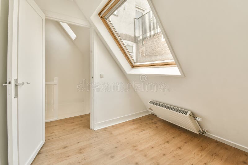 A Loft Conversion with a Window and a Wooden Floor Stock Photo - Image ...