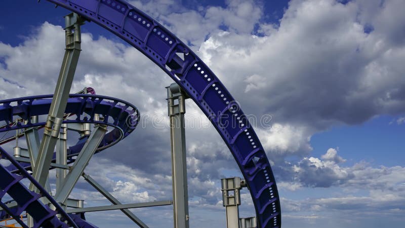 Video: Attraction roller-coaster switchback on the background of the ...
