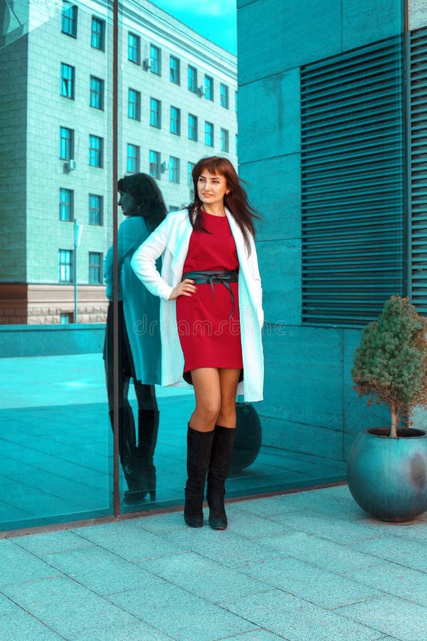 Attractive Adult Brunette Female Posing Next To Mirror Wall Stock