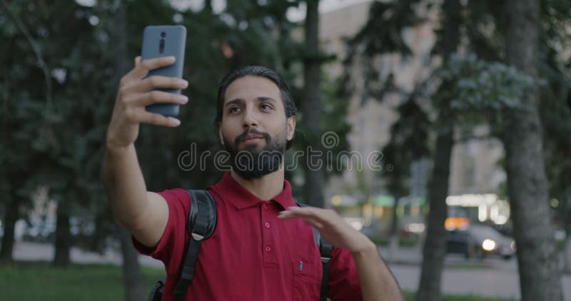 Attractive Arab Man with Backpack Making Online Video Call Talking ...