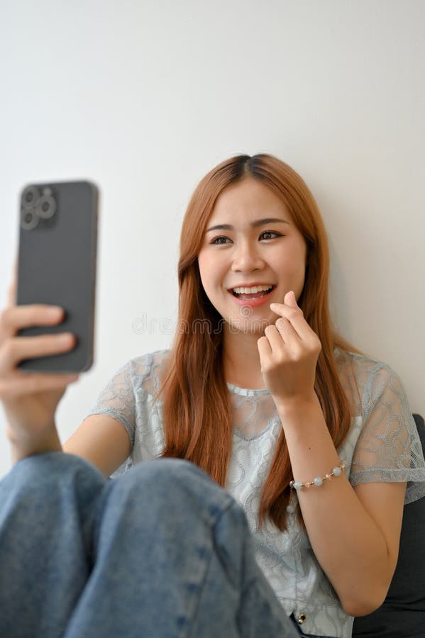 Attractive Asian Female Having A Video Call Or Taking A Selfie By Her