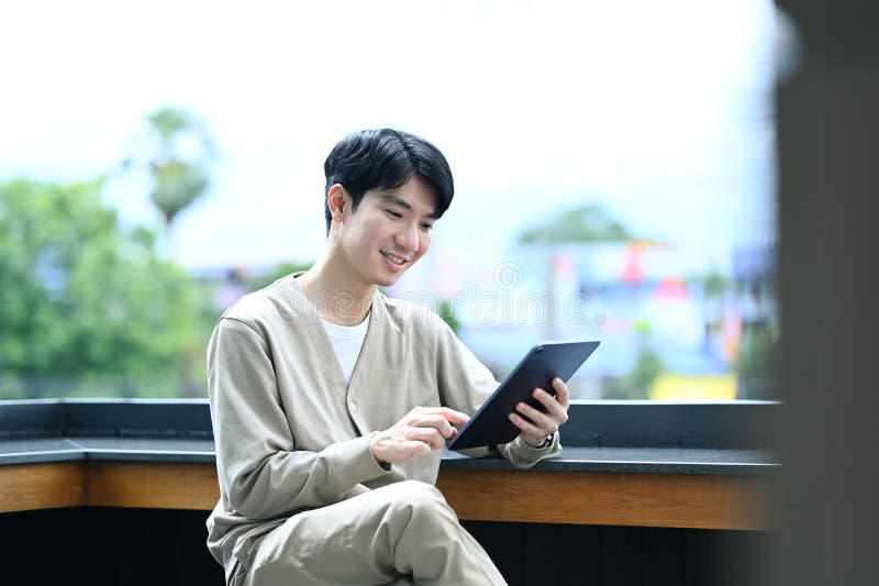 Attractive Asian Man Using Digital Tablet at Building Terrace on Sunny ...