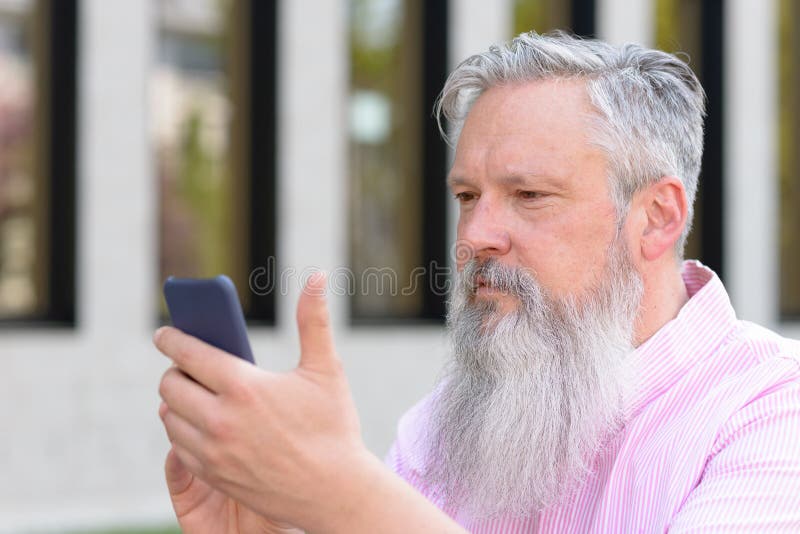 Attractive Bearded Man Reading a Text Message Stock Image - Image of ...