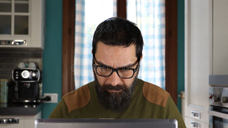 Attractive Bearded Man Working on Computer. Sitting at Desk in Home ...