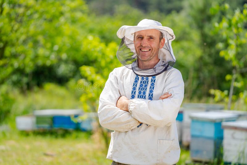 Attractive Beekeeper Working in Apiary. Handsome Man in Beekeeper Hat ... Attractive Beekeeper Working in Apiary. Handsome Man in Beekeeper Hat ...