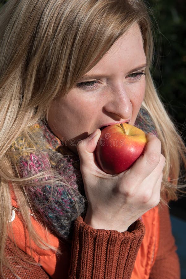 Attractive Blond Woman Biting into an Apple Stock Photo - Image of ...