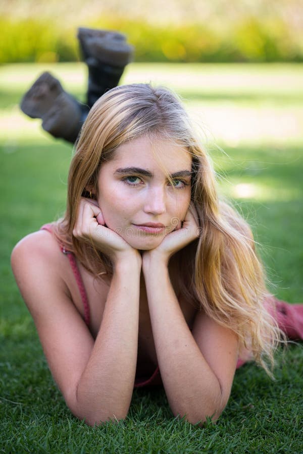 Attractive Blonde Caucasian Girl With Blue Eyes Posing In Soft Summer