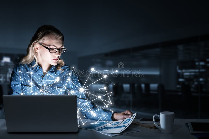 Attractive Blonde Wearing Glasses in Dark Office Using Laptop. Mixed ... Attractive Blonde Wearing Glasses in Dark Office Using Laptop. Mixed ...