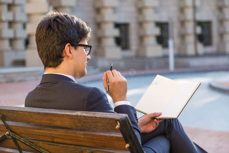 Attractive Businessman Writing in Notepad Stock Image - Image of ...