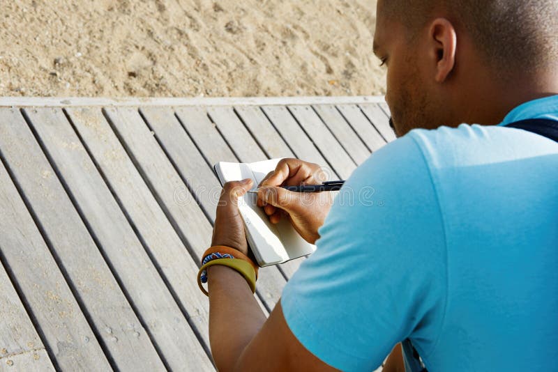 Attractive Casually Dressed Young American African Man Making Notes in ...