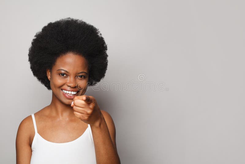 Attractive Cheerful Woman Smiling And Pointing Finger At Camera Stock