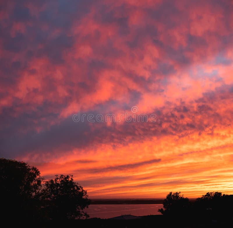 Attractive Colours and Textures of Clouds at Sunset Over a Bay of Water ...