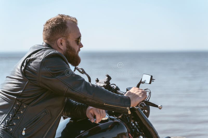 Side View of a Handsome Bearded Biker Posing while Sitting on His ...