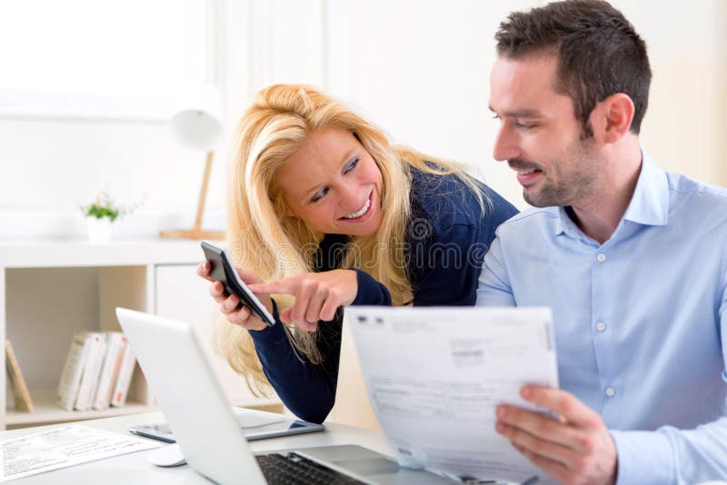 Attractive Couple Doing Administrative Paperwork Stock Photo - Image of ...