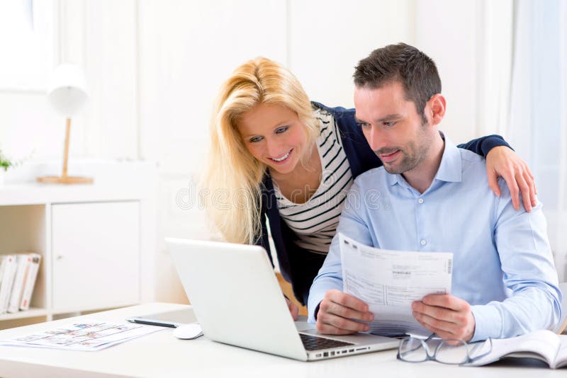 Attractive Couple Doing Administrative Paperwork Stock Photo - Image of ...