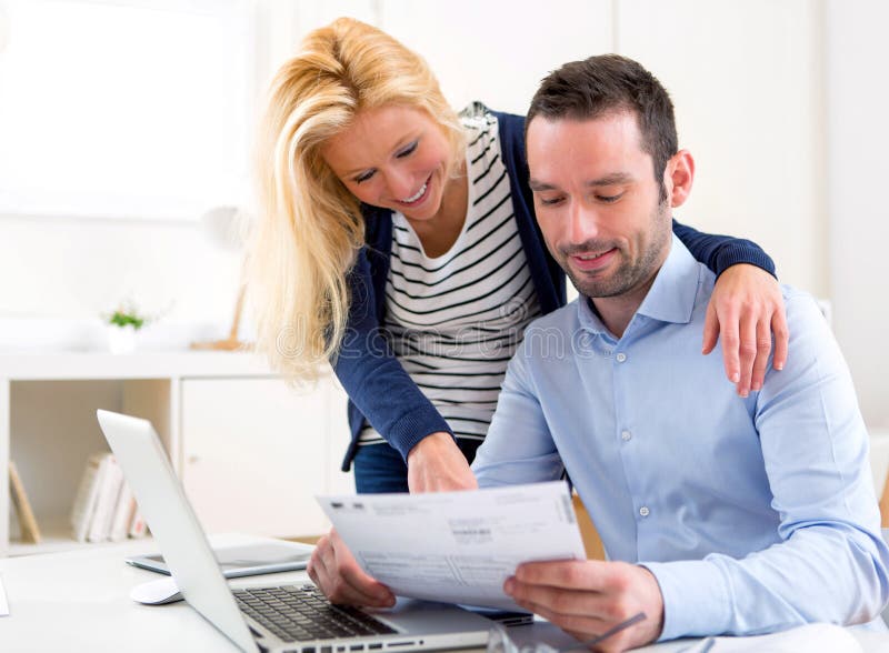 Attractive Couple Doing Administrative Paperwork Stock Photo - Image of ...